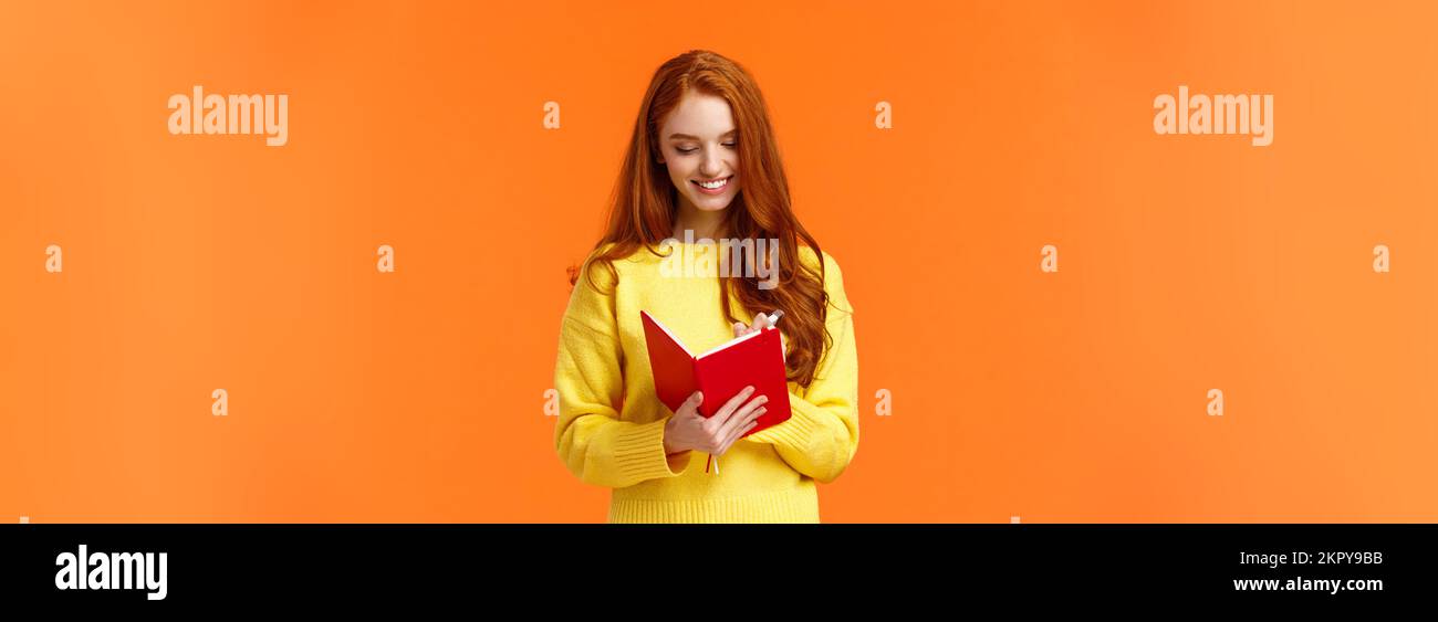 Waist-up portrait attractive redhead girl 20s write in her diary, fill ...