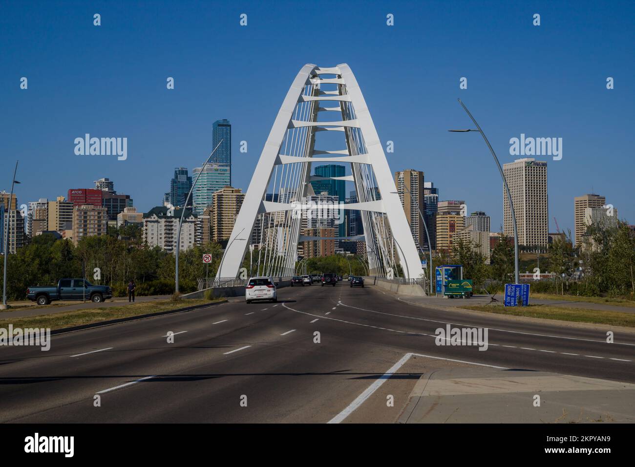 Modern arc bridge over the river, day traffic, summer time. modern ...