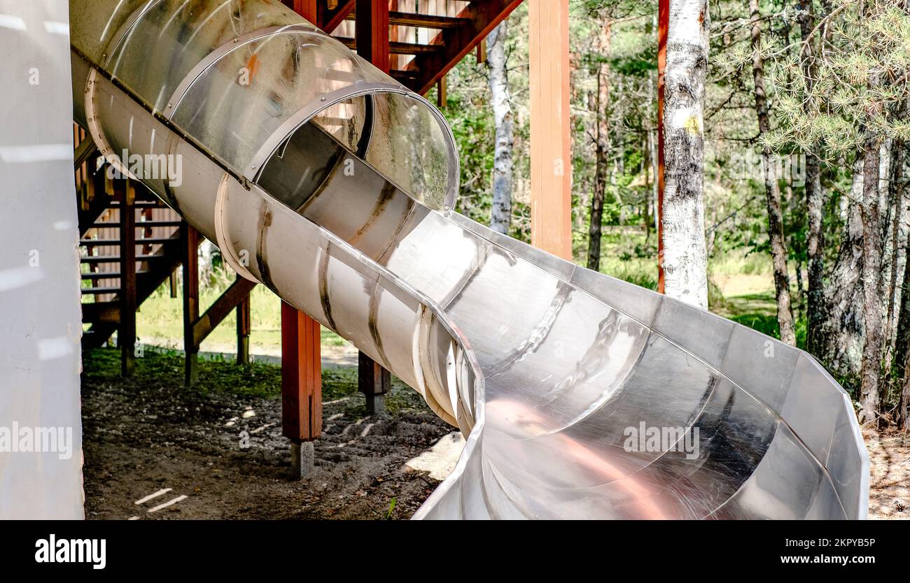 Children's slide in the form of a pipe in an amusement park. Recreation ...