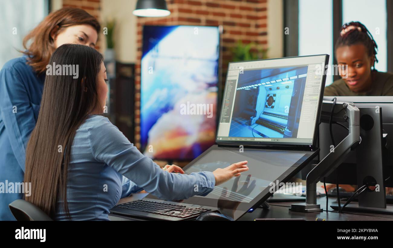 Team of people working with touchscreen display for gaming app ...