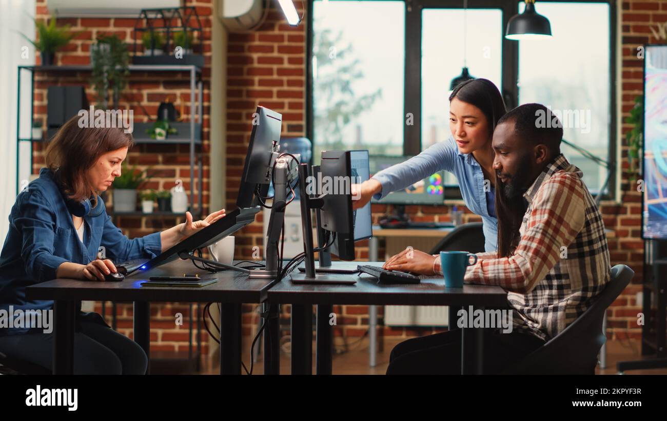 Young team of professional developers using skills to create ... Young team of professional developers using skills to create ...