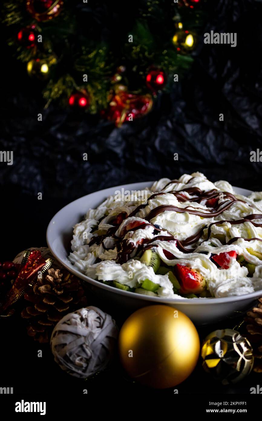 Fruit dessert with chocolate and cream topping in the bowl, Christmas ...