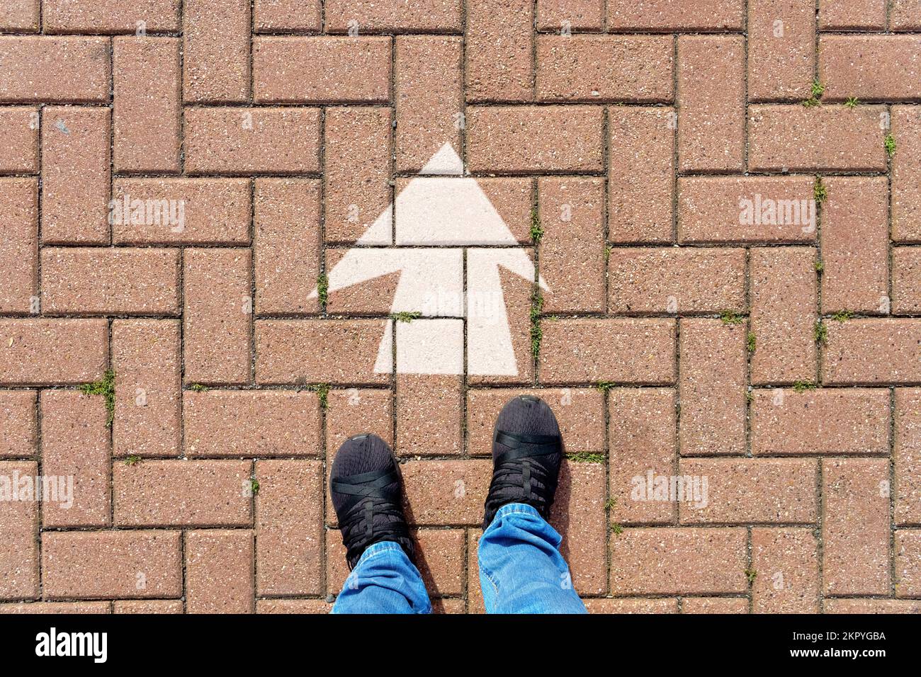 Selfie of feet and arrows on the road. top view. Businessmen in black ...