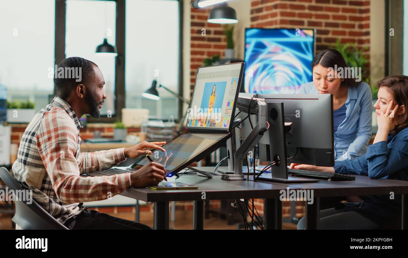 Male graphic designer editing pictures on retouching software, working ...