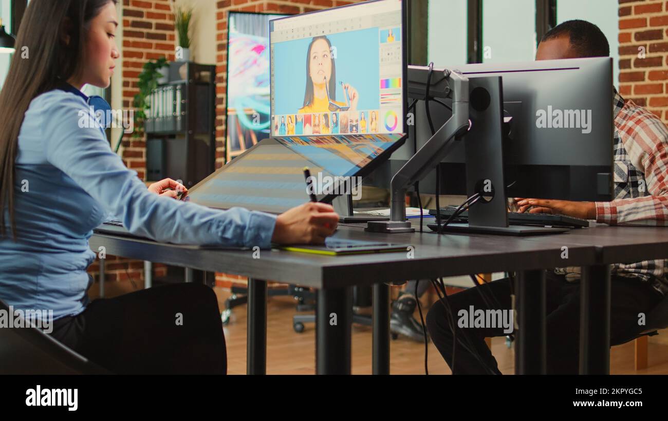 Creative company employee working with touchscreen display to edit ...