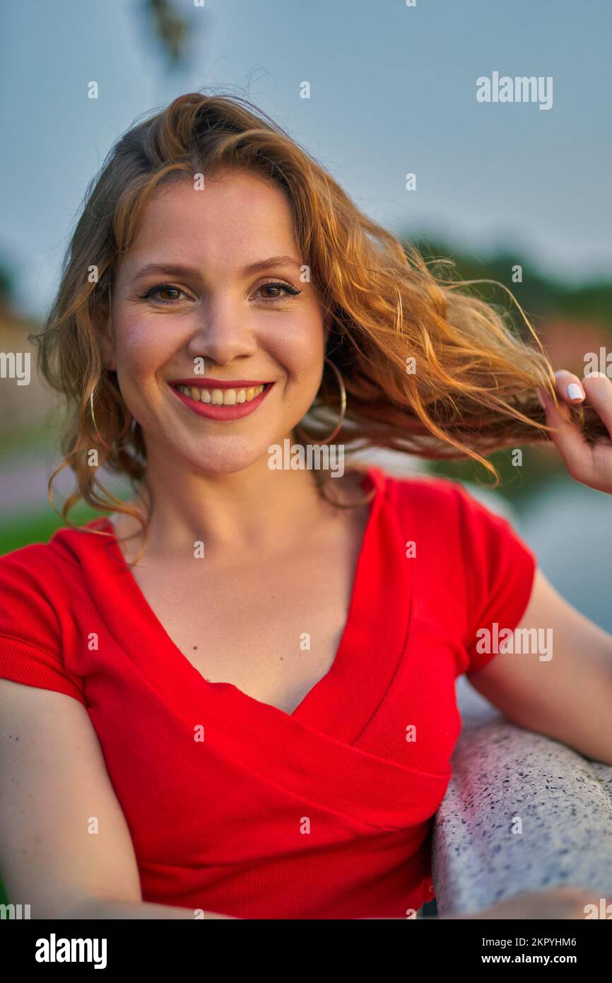 Outdoor portrait of young smiling woman in Kaliningrad Stock Photo - Alamy