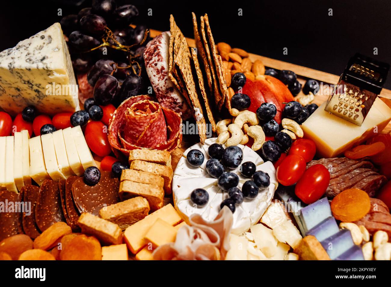 Cheese platter, cheese board meat and board. Vegetables and fruits with ...