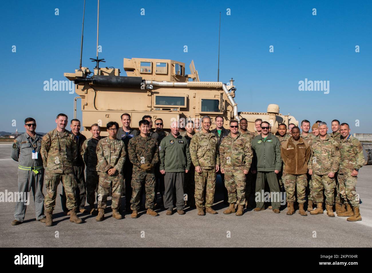 Airmen pose for a photo with Gen. Ken Wilsbach, center-right, Pacific ...