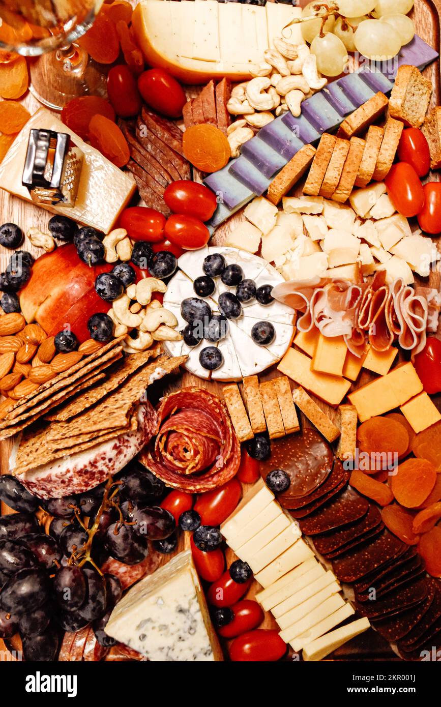 Cheese platter, cheese board meat and board. Vegetables and fruits with ...