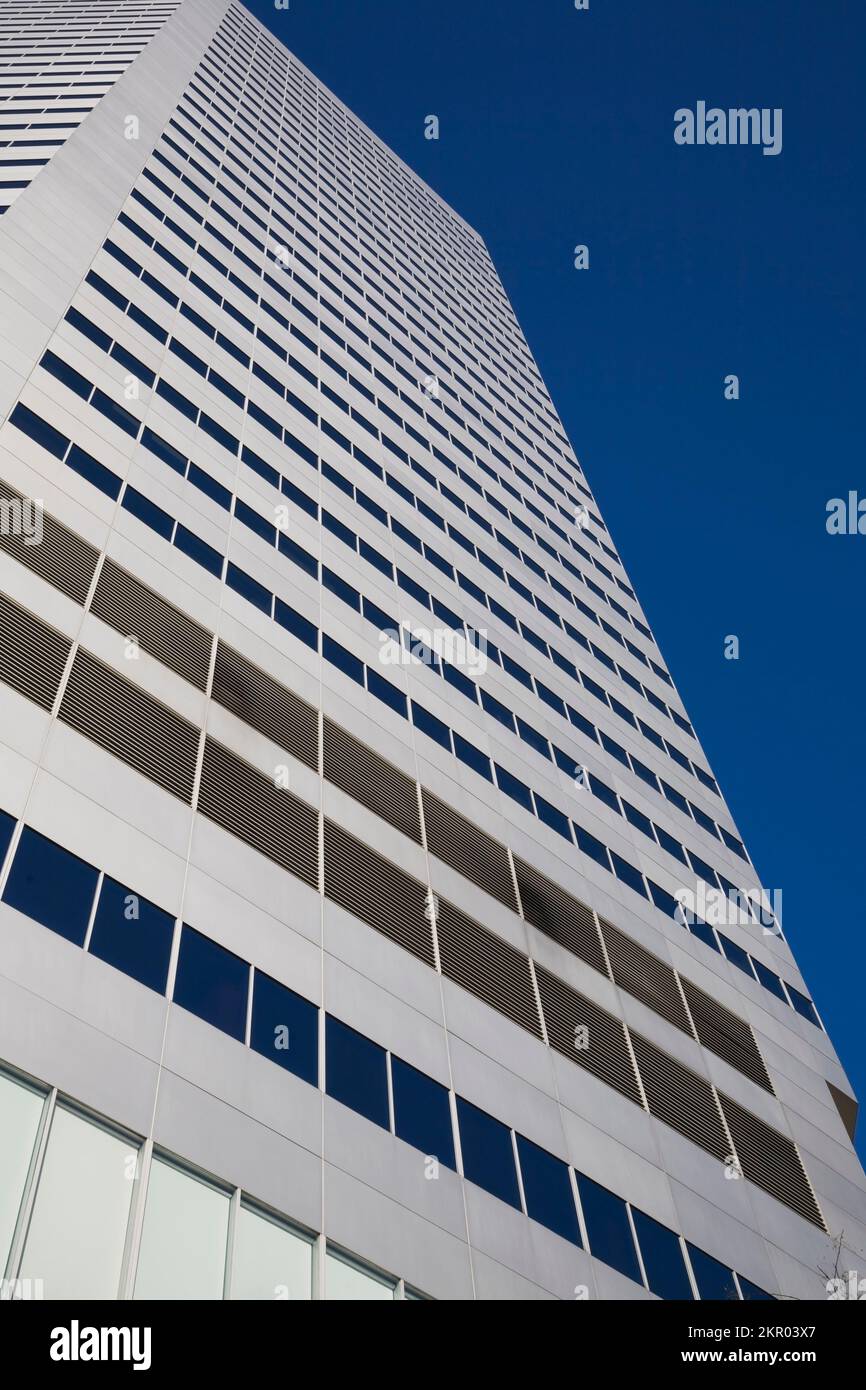 Modern architectural office tower building against blue sky background ...