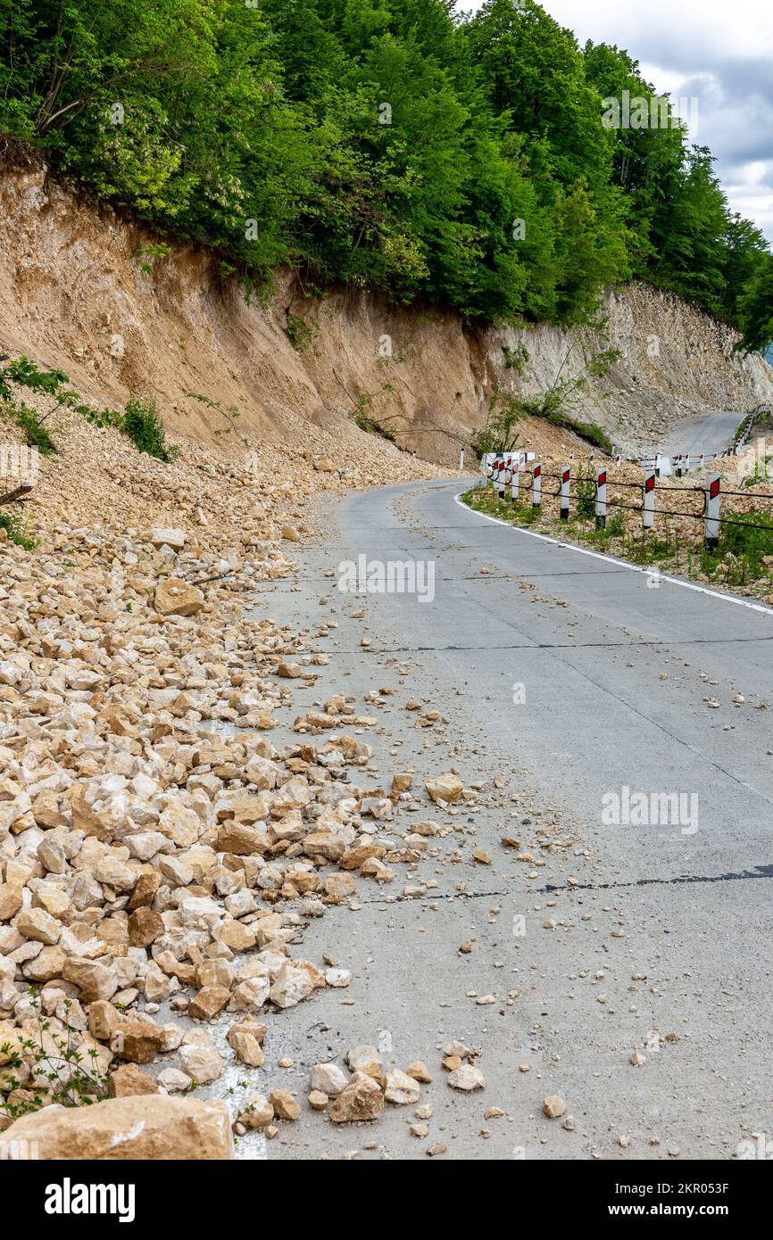 Limestone rockfall and landslide fallen on a tarmac road leading to ...