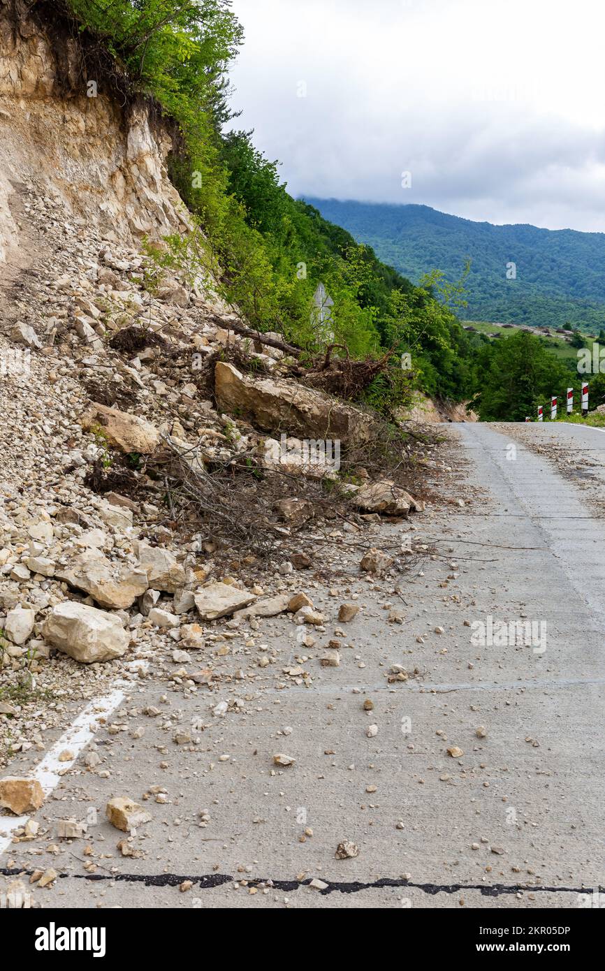 Limestone rockfall and landslide fallen and blocking tarmac road ...