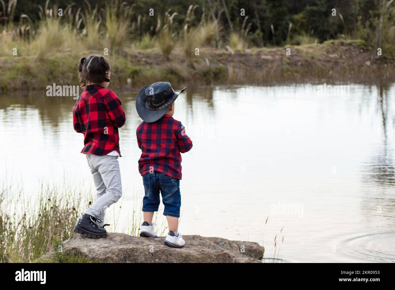 children throwing stones in a lagoon Stock Photo - Alamy