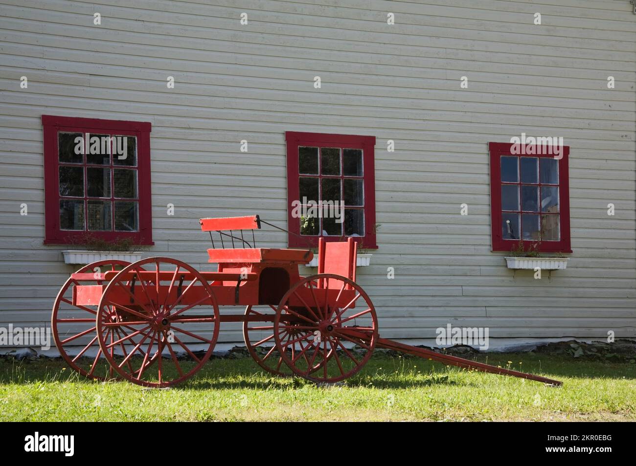 Red antique wagon in front of old white barn Stock Photo - Alamy