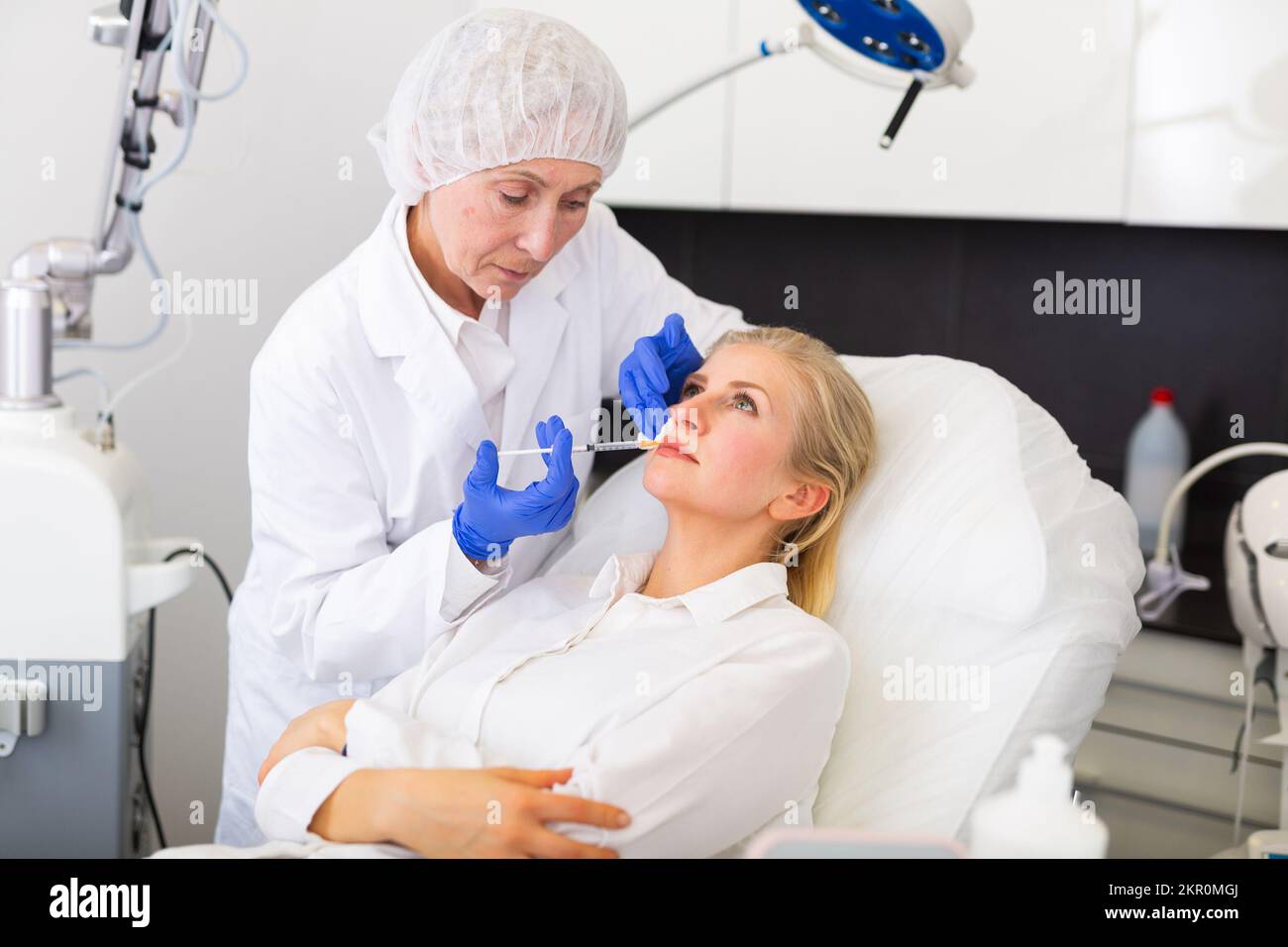 Cosmetologist doing botulotoxin injections for young woman Stock Photo ...