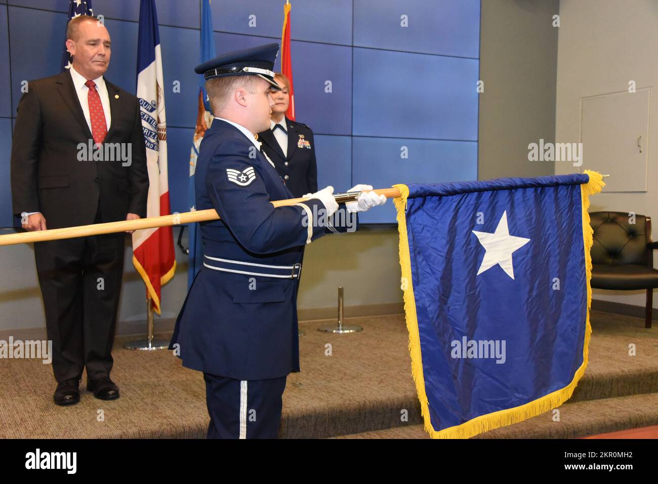 A member of the Honor Guard unfurls the general officer flag being ...