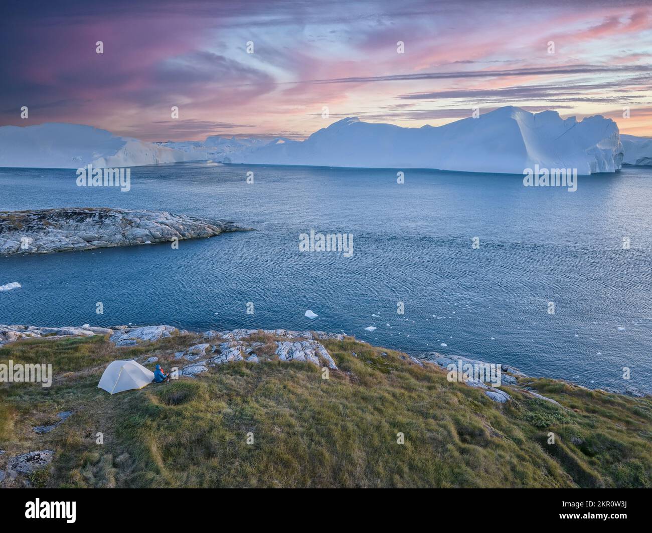 camping with a tent in fron of big icebergs Stock Photo - Alamy