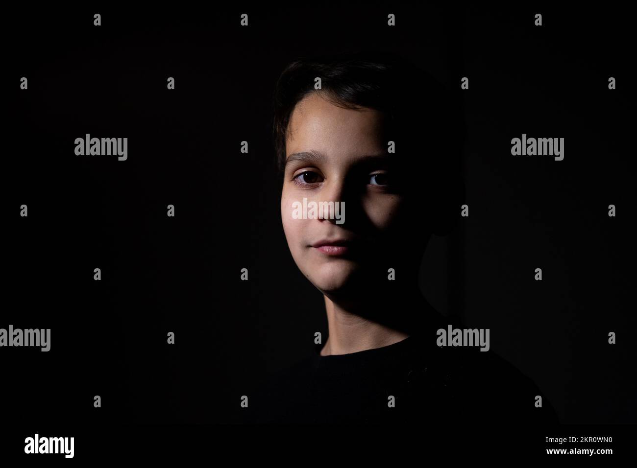 Low Key Portrait Of Boy In Rembrandt Lighting Stock Photo - Alamy