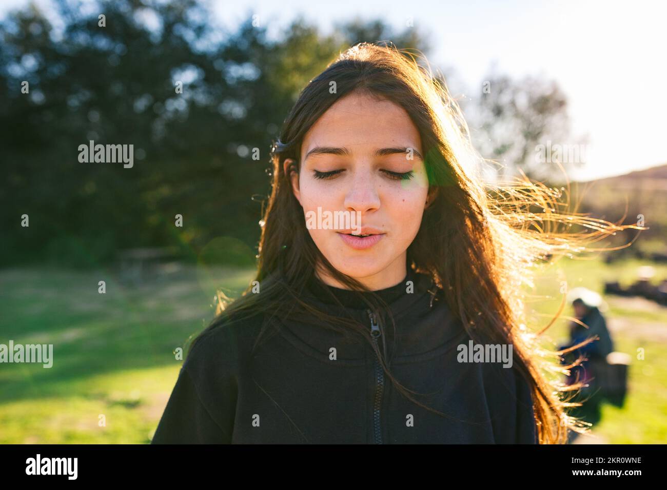 Happy Portrait Of Teen Girl Looking Down While outside Stock Photo - Alamy