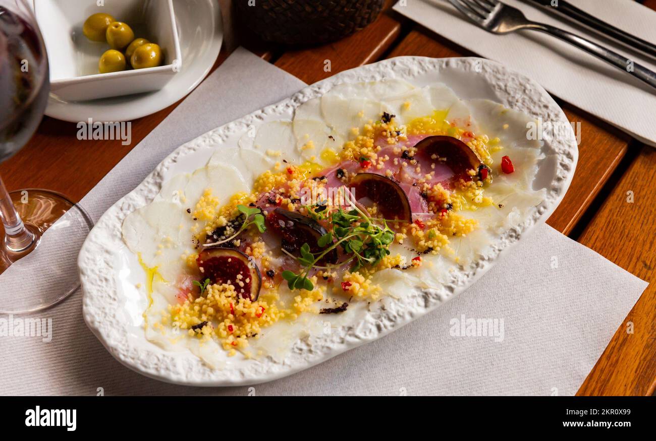 Delicious fish dish - cod carpaccio Stock Photo - Alamy