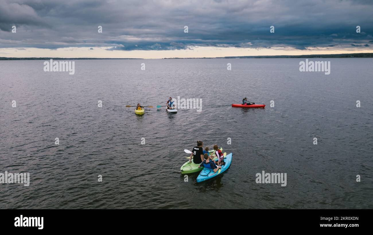 Group of people in kayaks on lake living active lifestyle Stock Photo ...