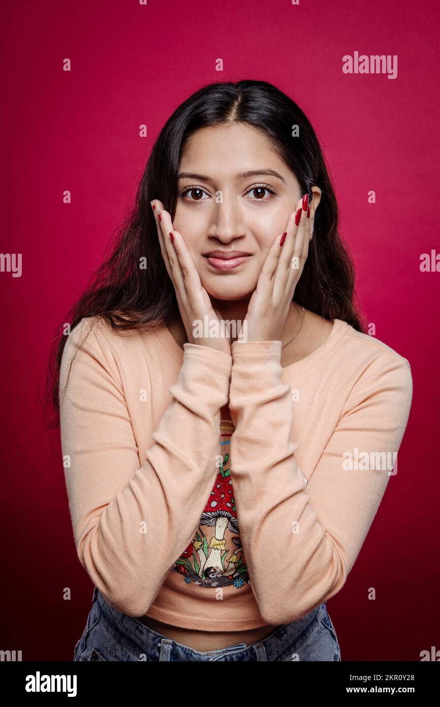 Charming Woman Touching Face With Hands Stock Photo - Alamy