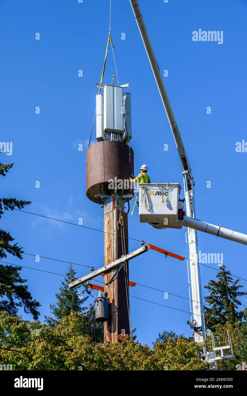 BELLEVUE, WA, USA – SEPTEMBER 30, 2022: two linemen up in the air ...
