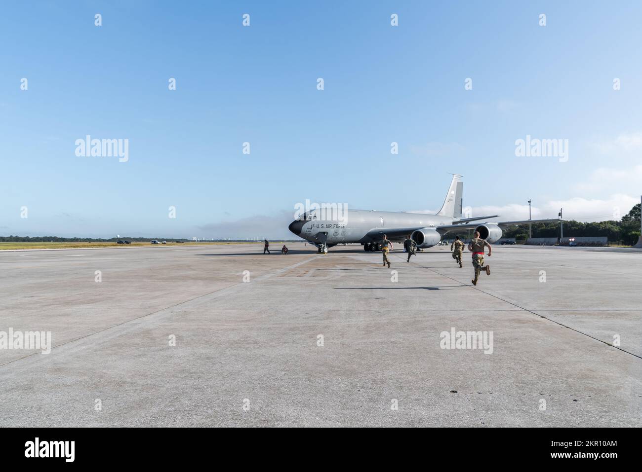 Airmen assigned to the 6th Air Refueling Wing run toward a KC-135 ...