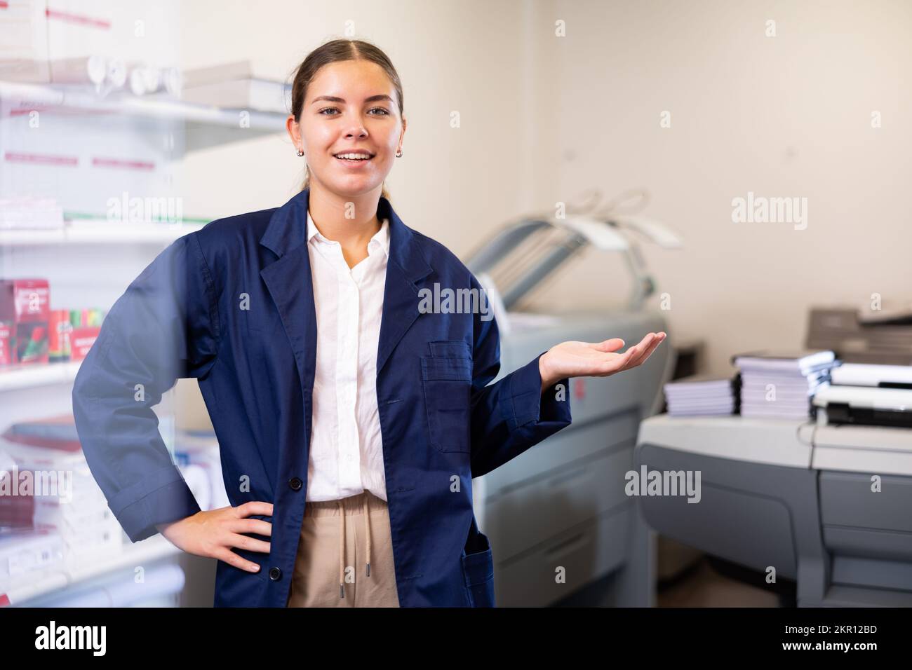 Cheerful young woman in blue robe uniform sticking out her left hand to ...