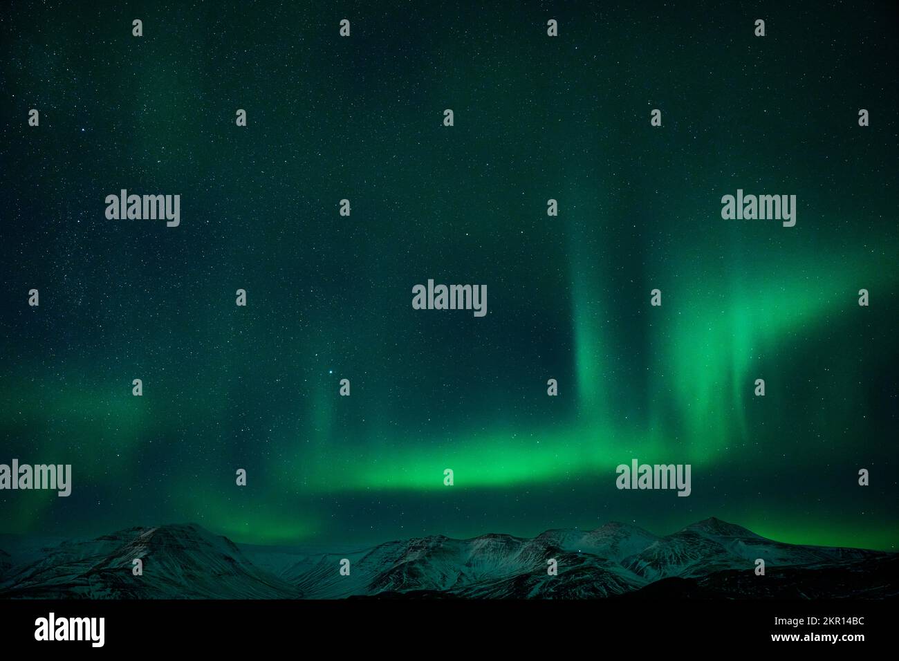 Green northern lights over mountain Stock Photo - Alamy