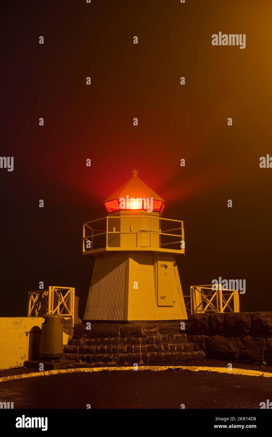 Lighthouse with red beacon in evening time Stock Photo - Alamy