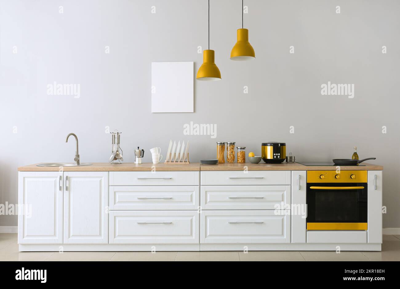 Interior of light kitchen with modern yellow oven Stock Photo - Alamy