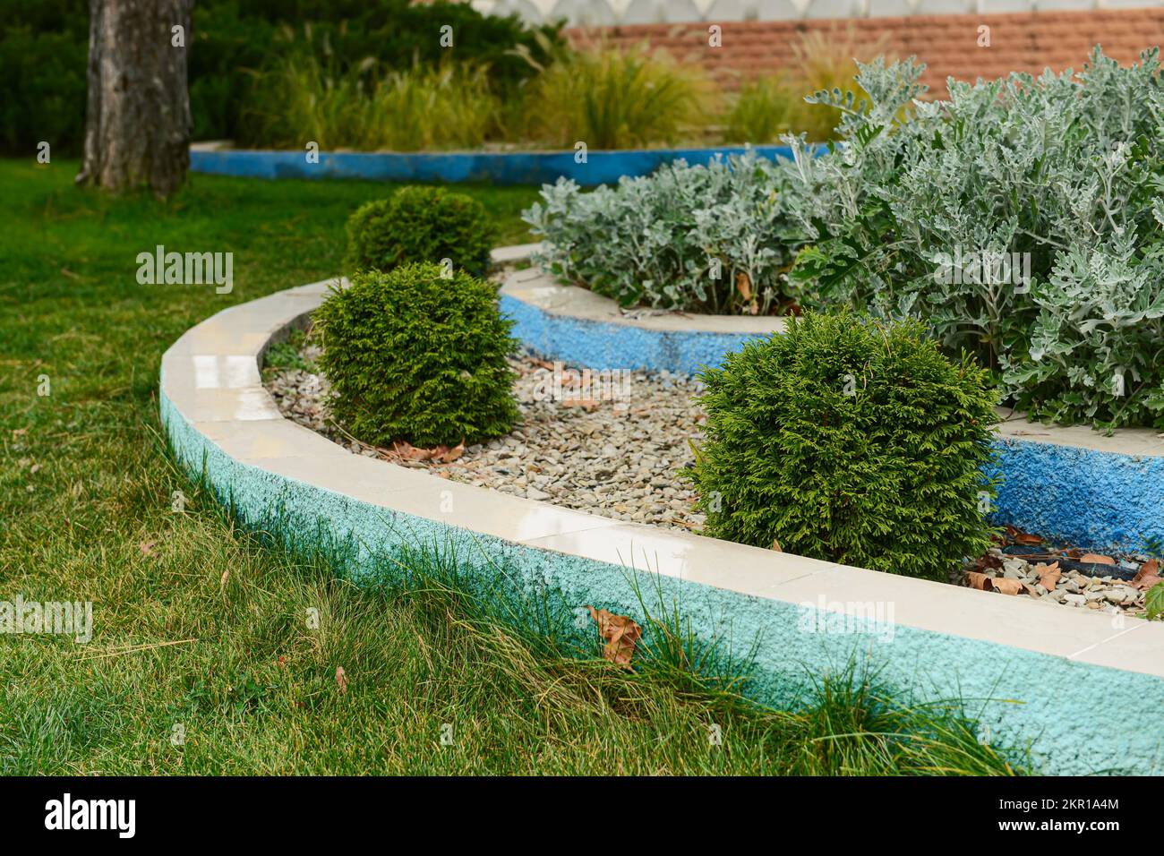 Landscape design with green bushes in city park Stock Photo - Alamy