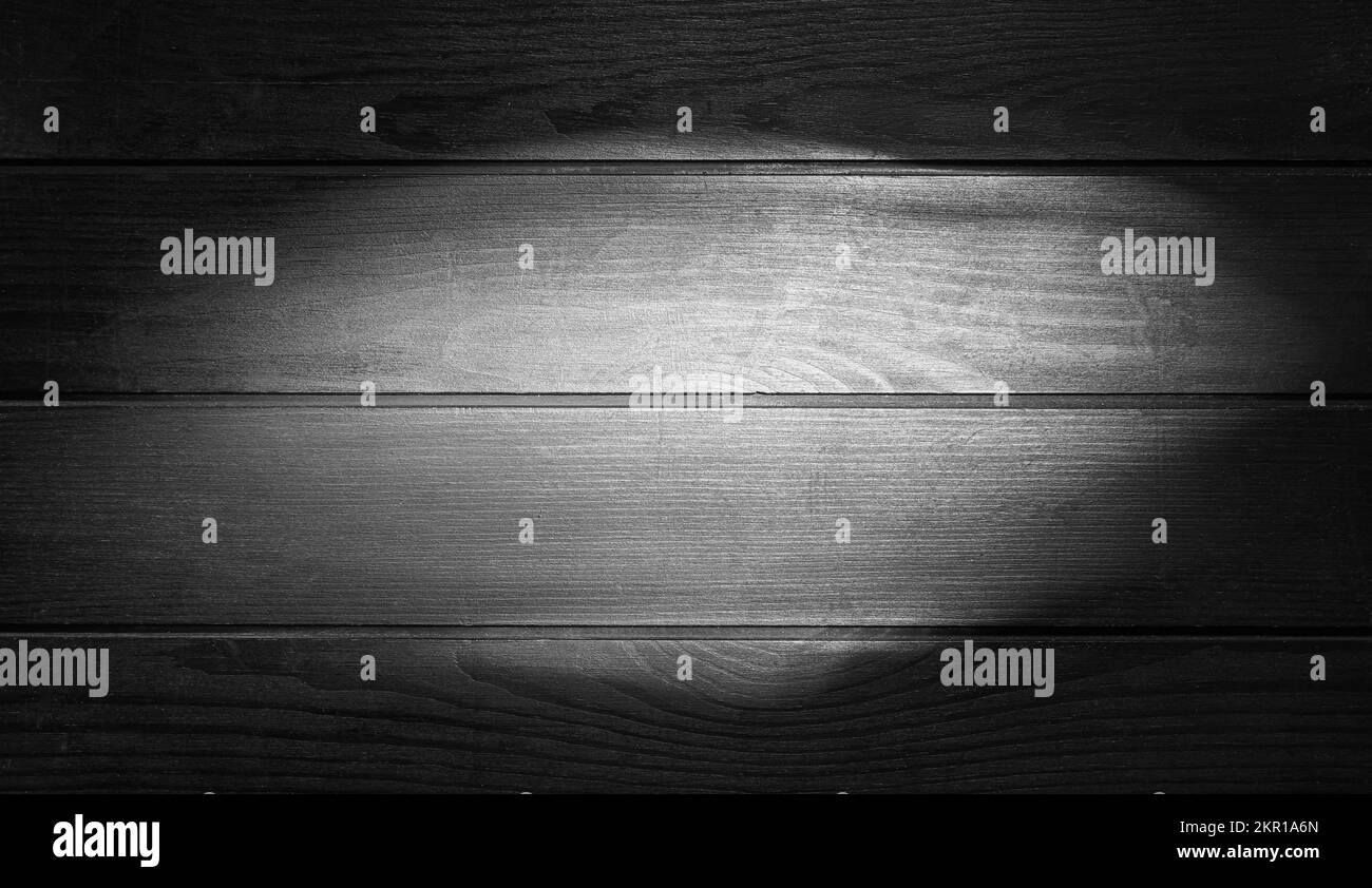 Backlight on black wooden texture as background Stock Photo - Alamy