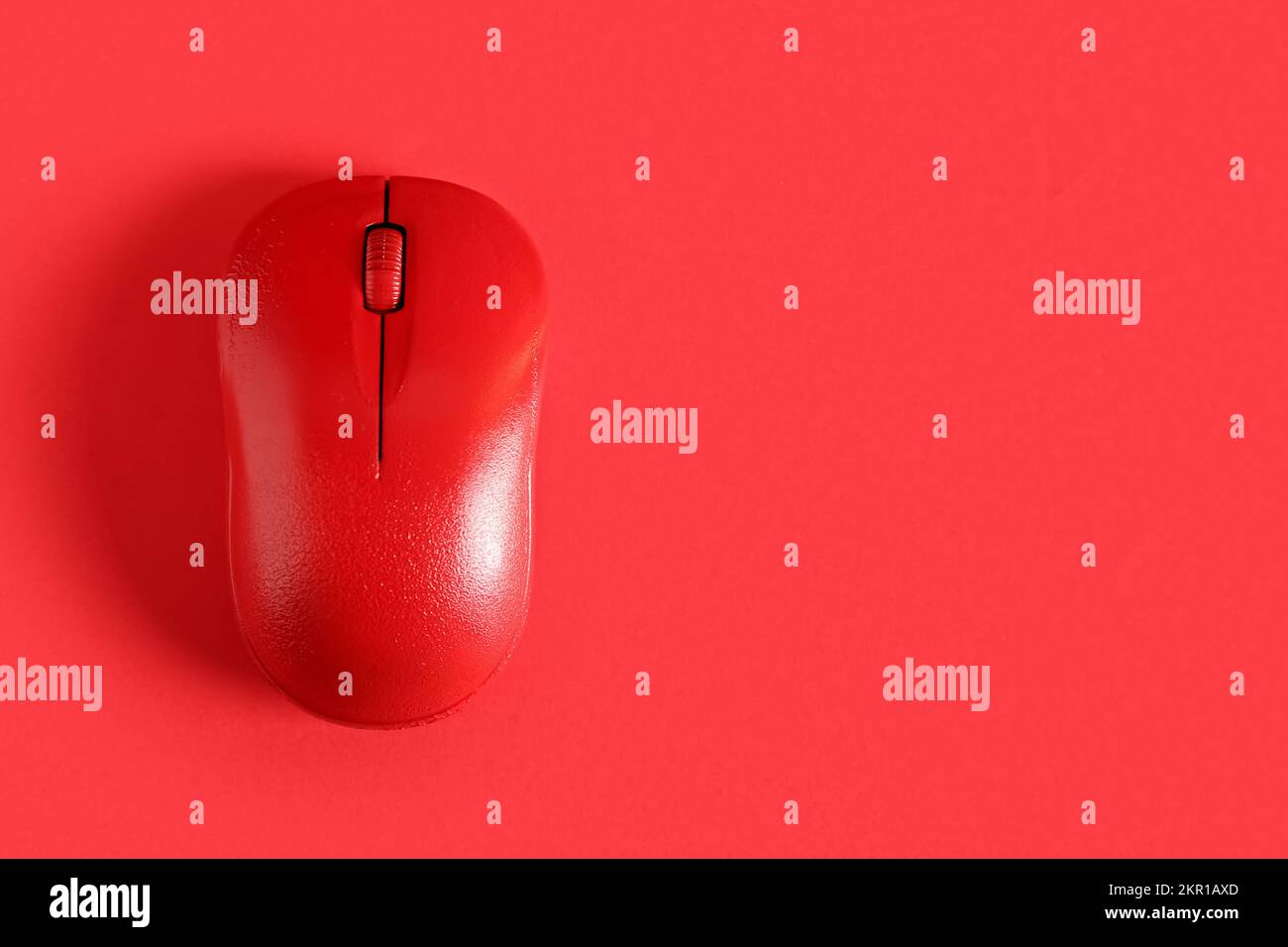 Red computer mouse on color background Stock Photo - Alamy