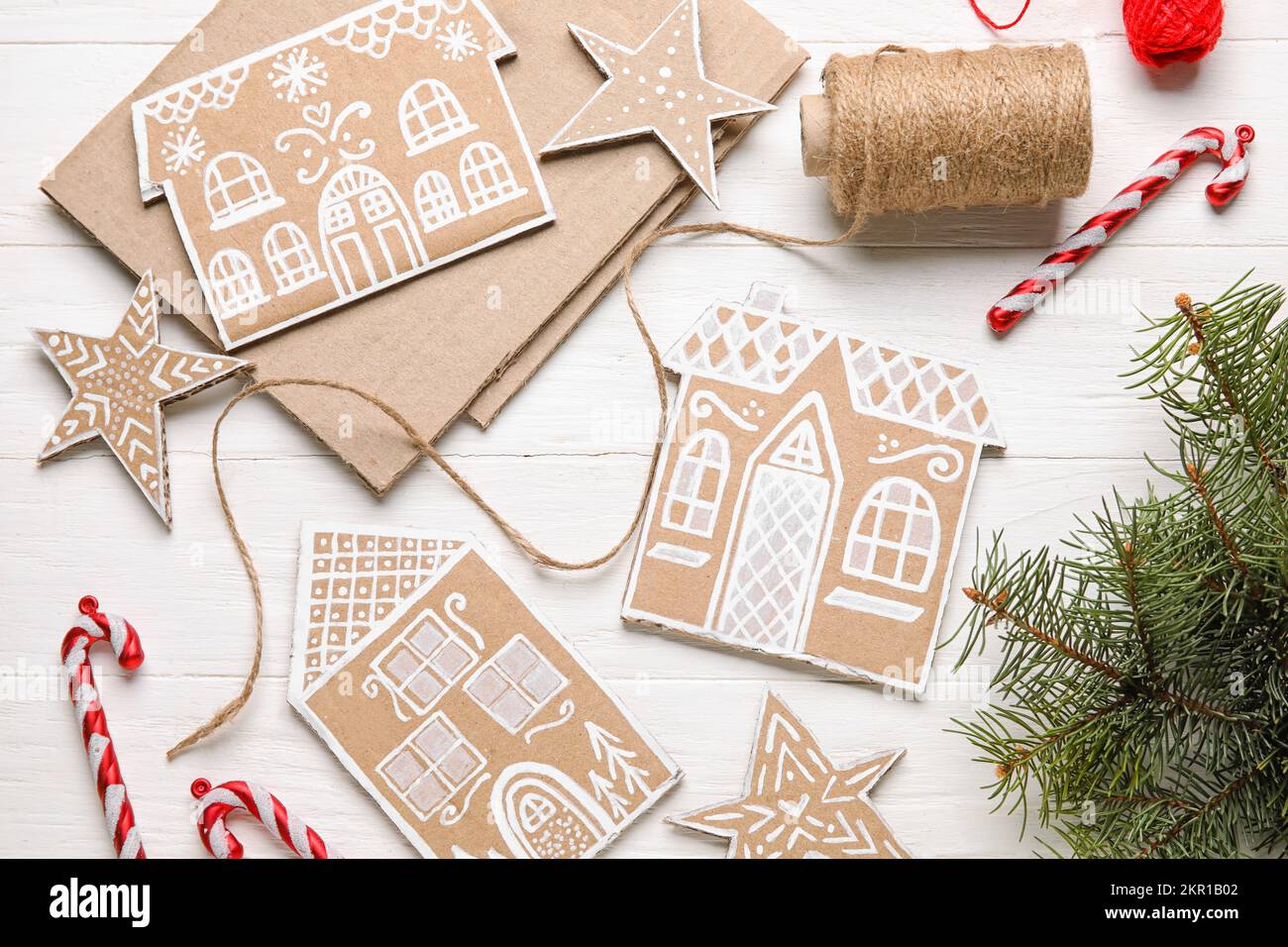 Christmas cardboard toys with candy canes and fir branches on white ...