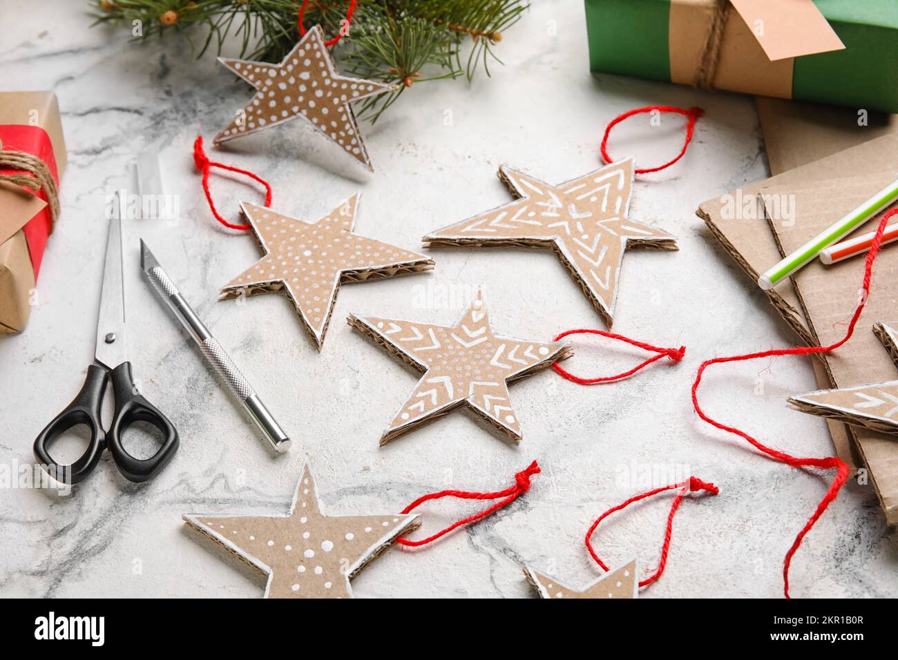Christmas cardboard stars with threads on light background, closeup ...