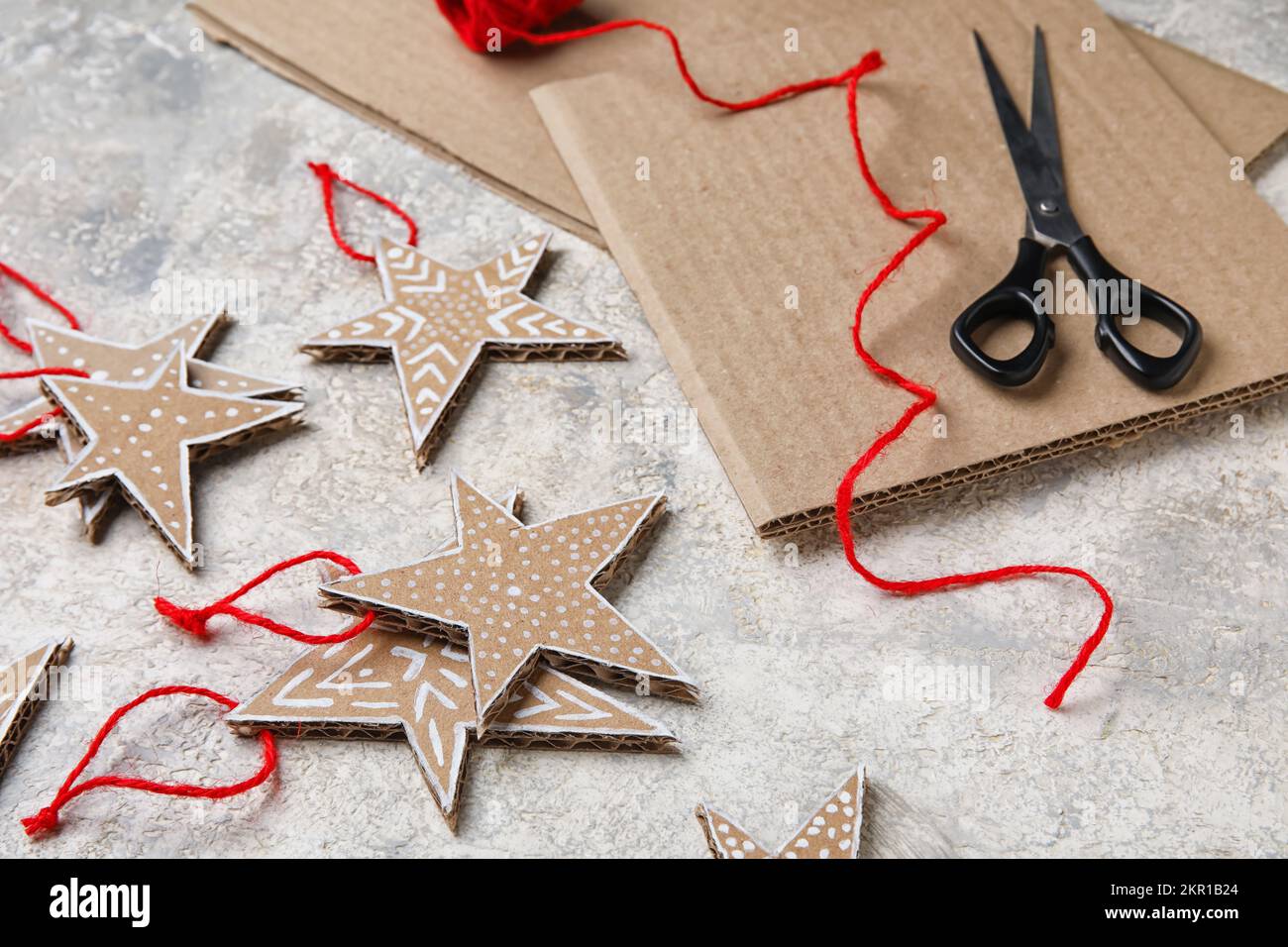 Christmas cardboard stars with threads and scissors on grunge ...