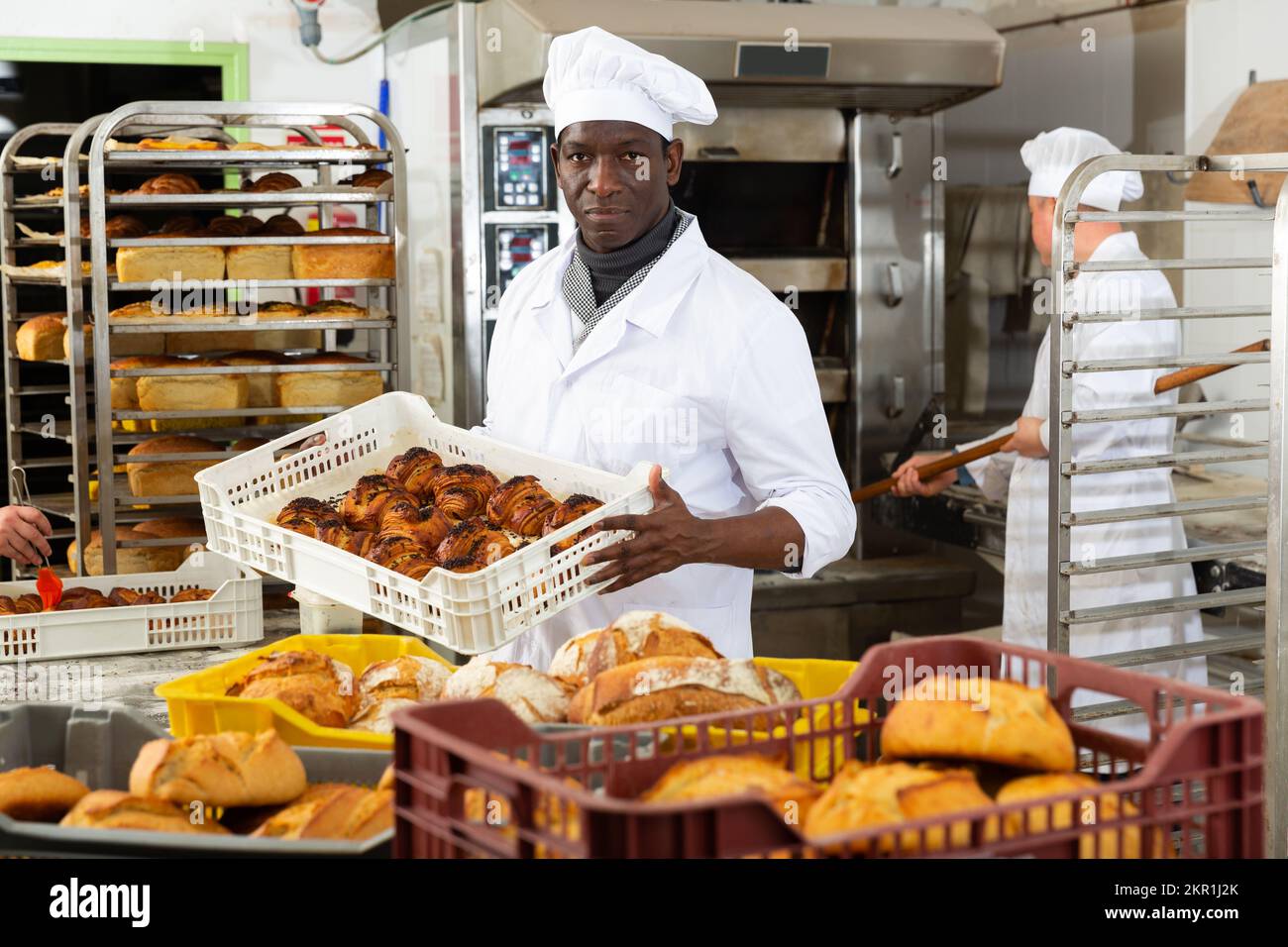African baker carrying bread in box Stock Photo - Alamy