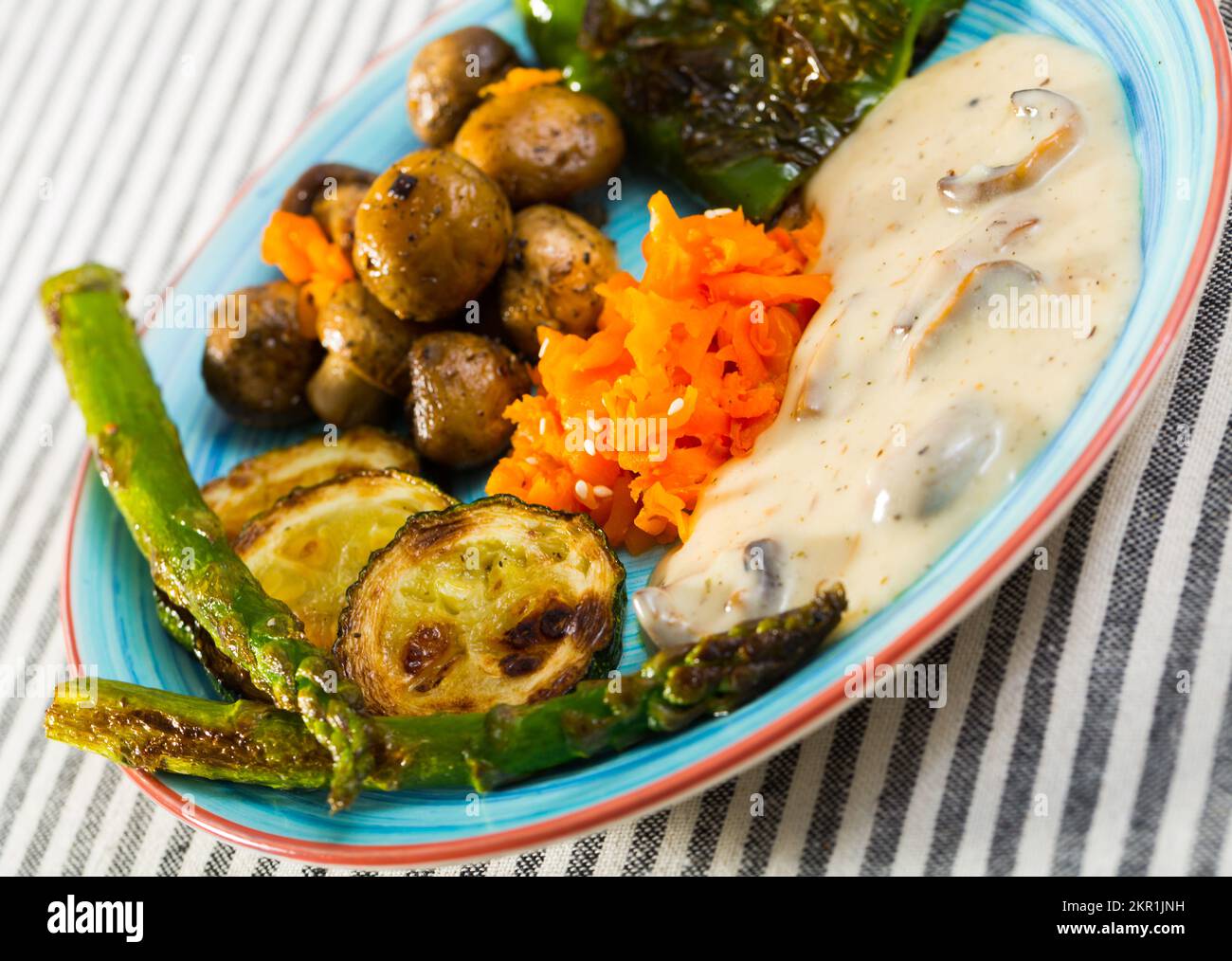 Grilled vegetables with mushroom sauce Stock Photo - Alamy