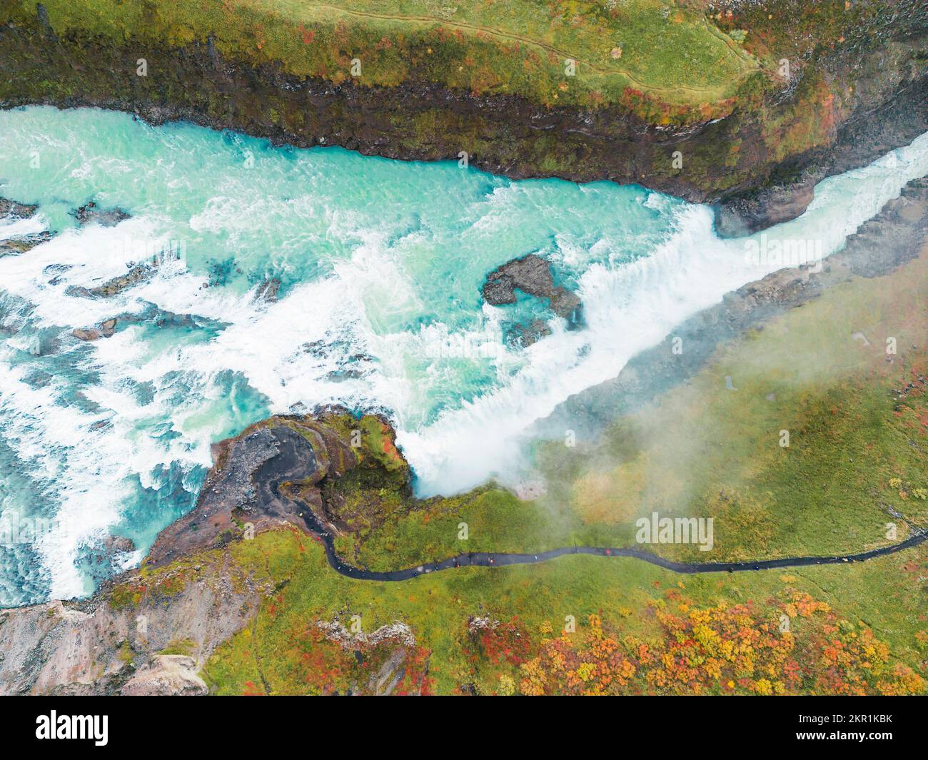 Birdseye view of water falling down the Gullfoss waterfall and tourists ...