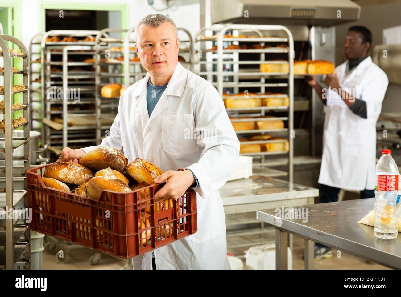 Baker sorts finished products at the bakery Stock Photo - Alamy
