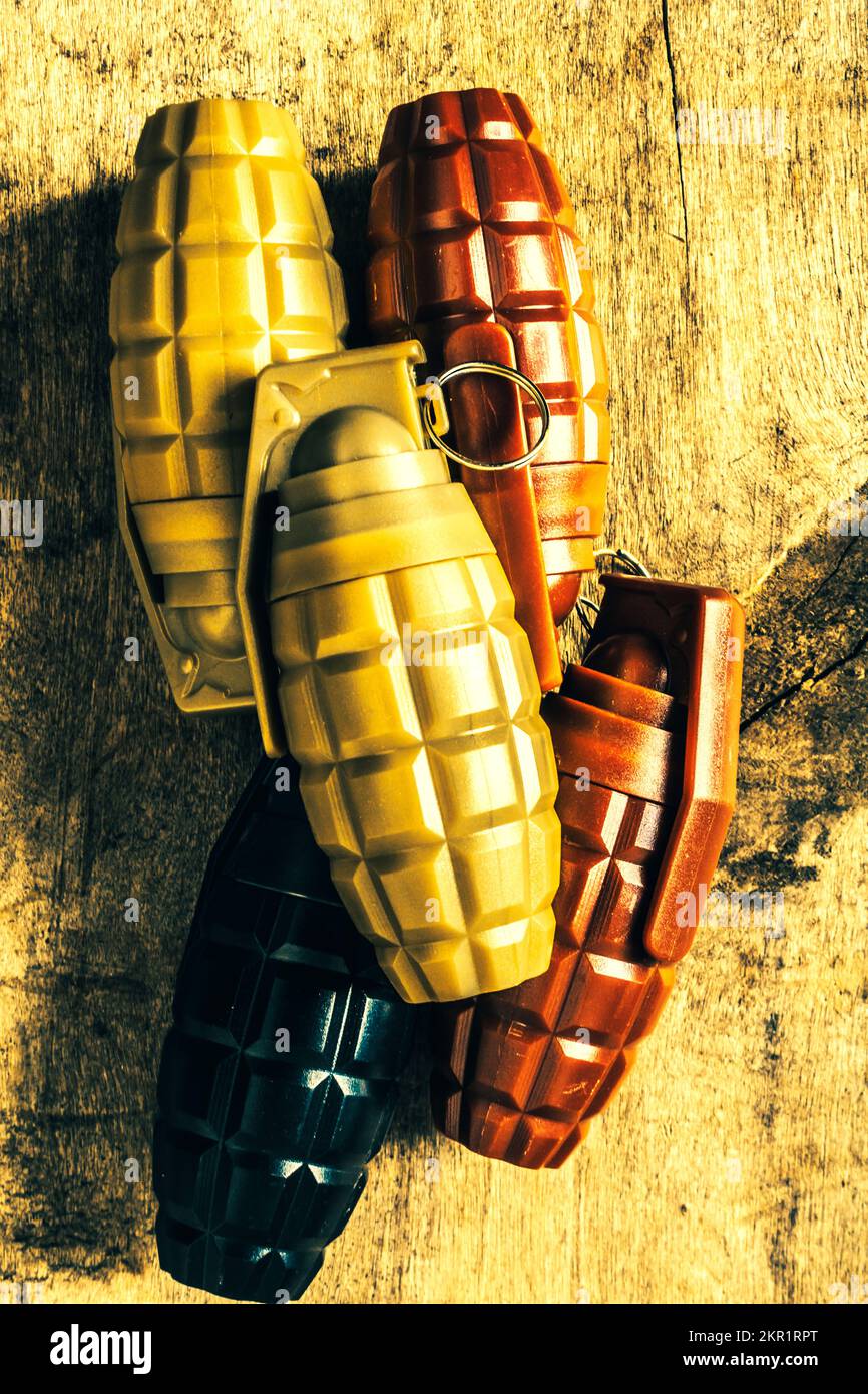 Scene of a visual impact with colourful military grenades on wood ammo ...