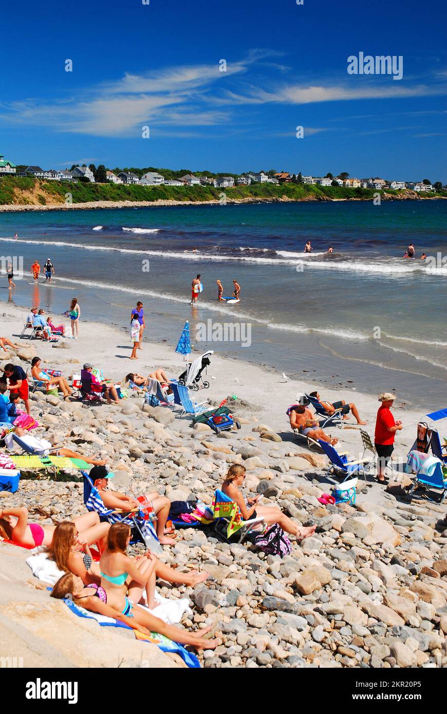 Sun bathers soak up the rays on a rocky beach in New England Stock ...