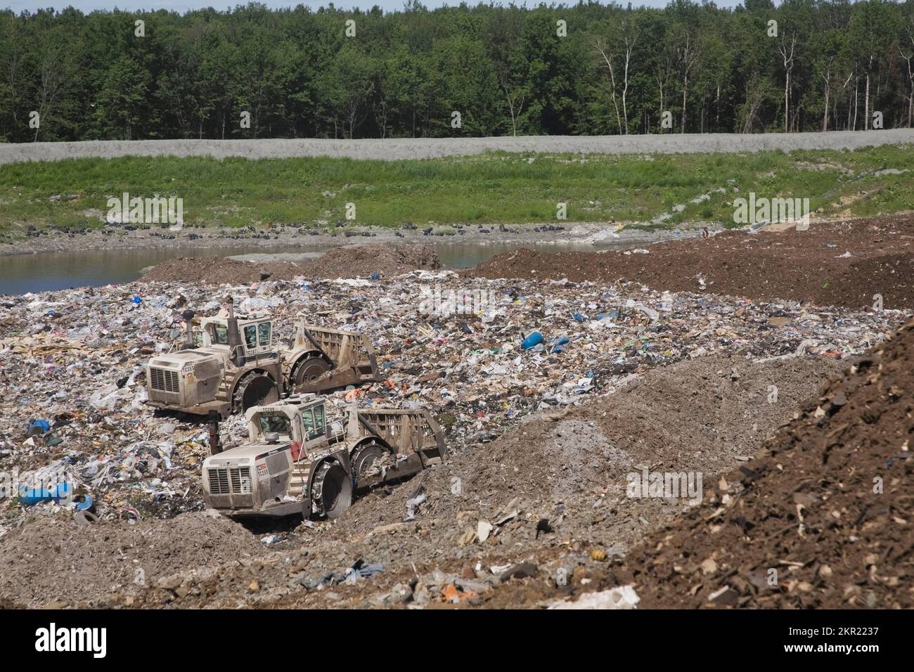 Terex TC550 landfill compactors spreading out and compacting discarded ...