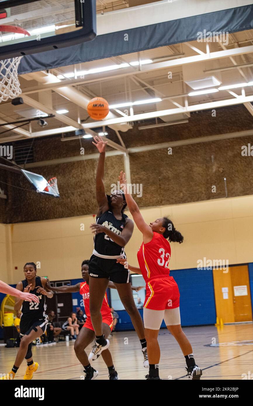 U.S. Army Spc. Malayasia McHenry, member of team Army, shoots a basket ...
