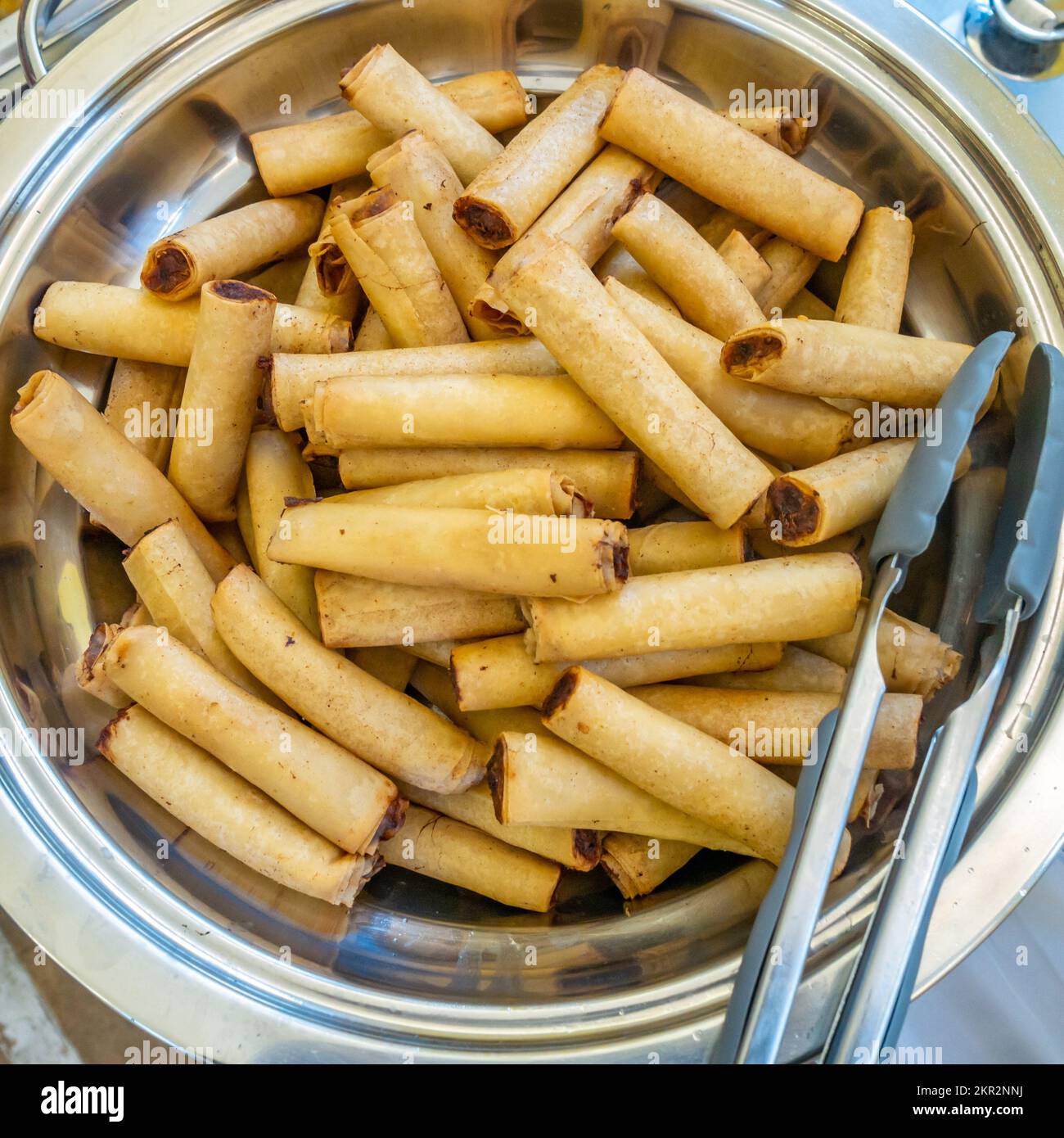 Looking down at spring rolls in a metal bowl at a buffet Stock Photo ...