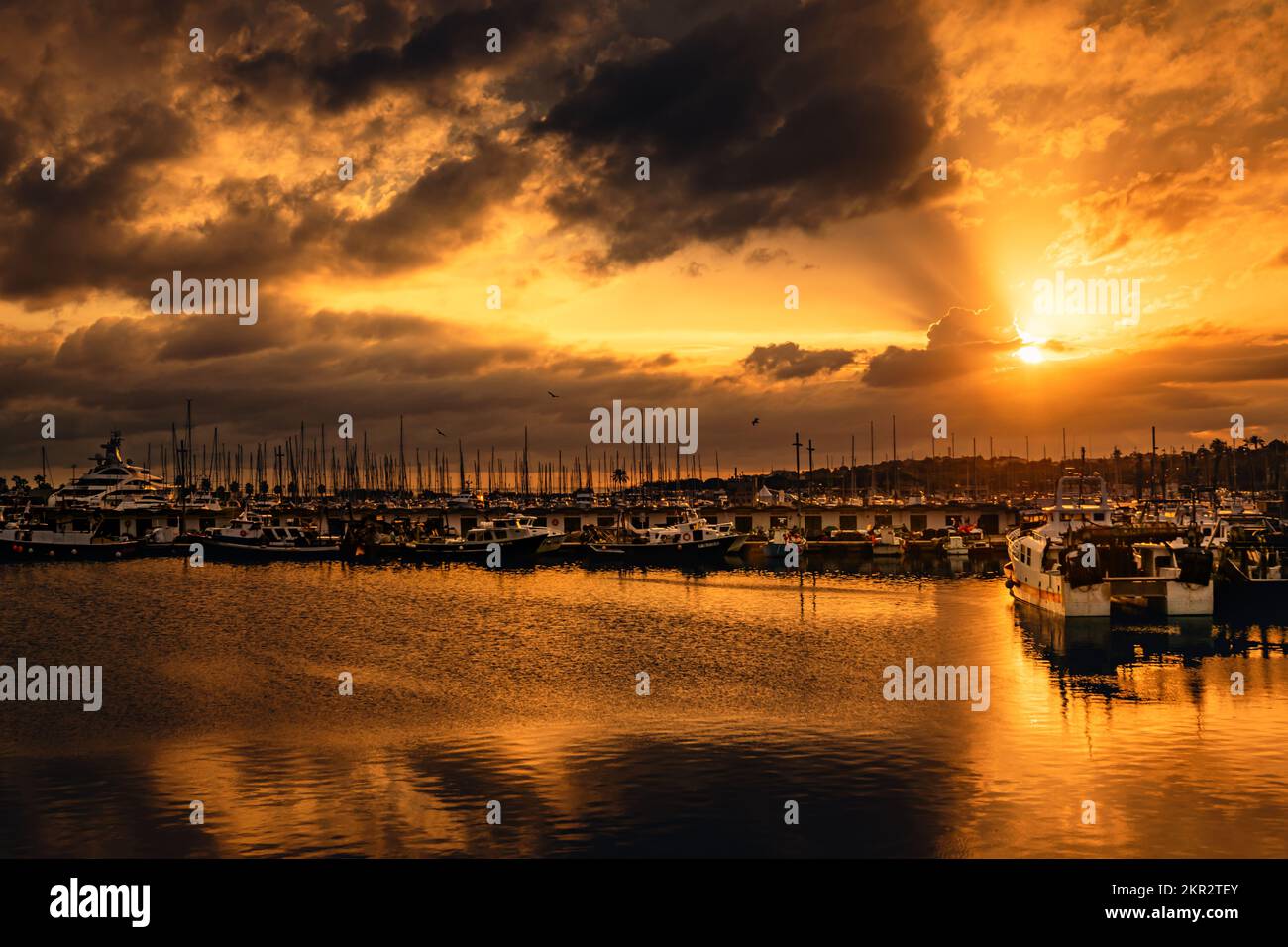 nice sunset in a port full of boats Stock Photo - Alamy