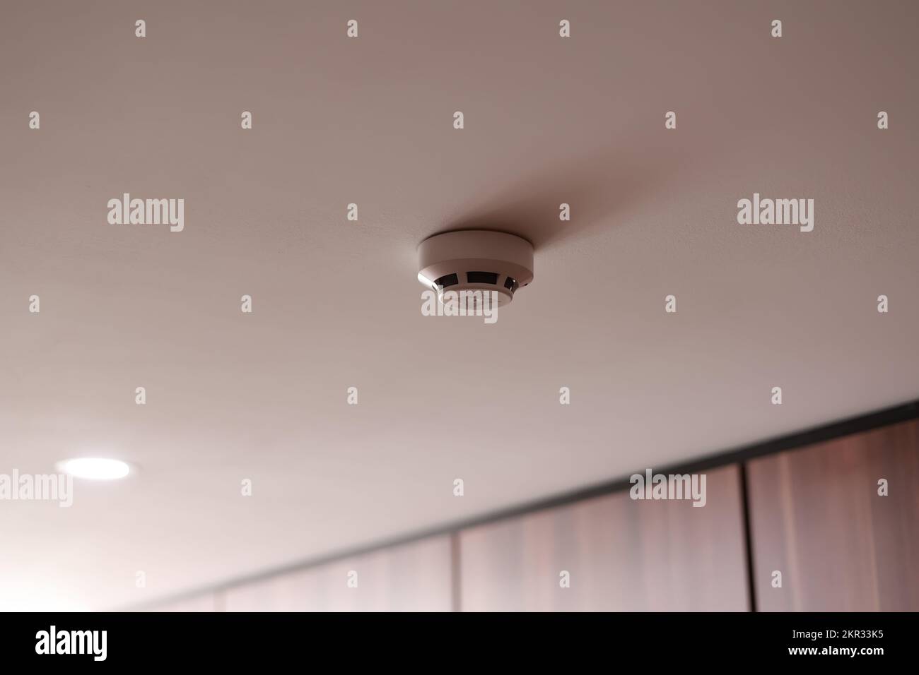 Fire system indoors. White smoke detector issue a signal to a fire ...