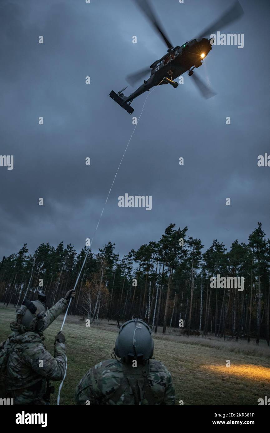 A Polish soldier, left, holds a drag line to prevent a hoisted litter ...